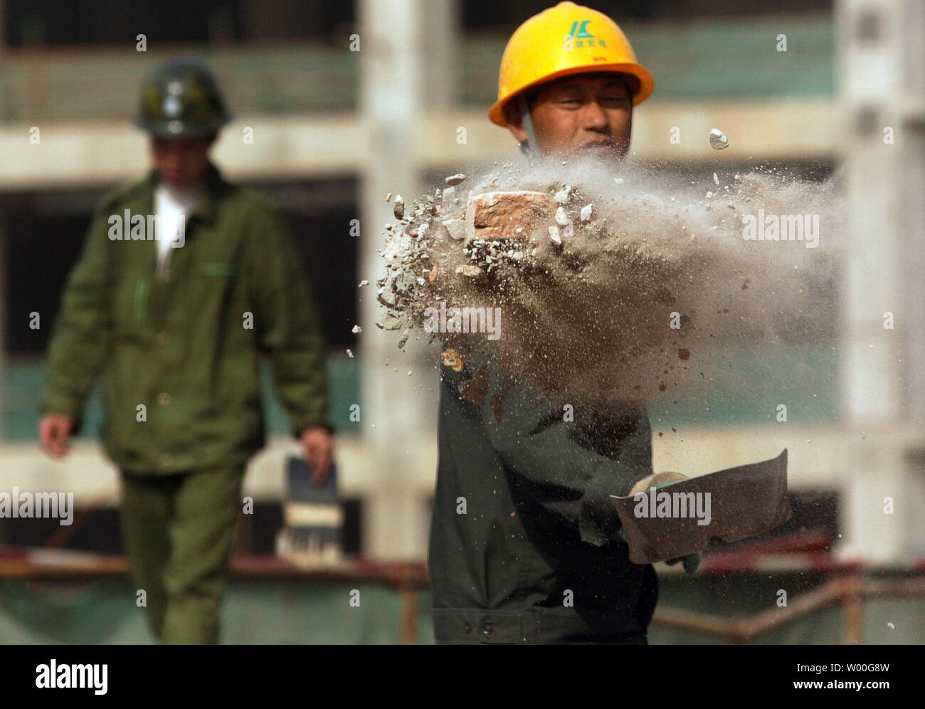 A construction worker clears a building site of rubble in downtown ...