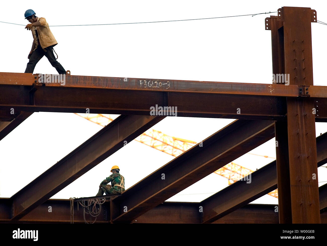 Steel workers walk the high beams at a construction site in downtown ...