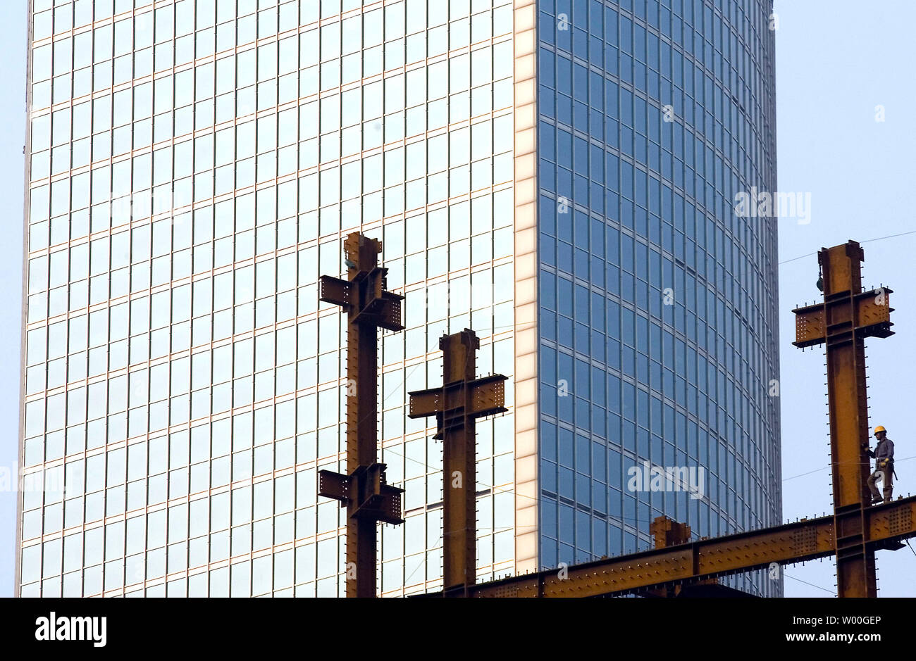 Chinese laborers work on steel girders at construction site in downtown ...