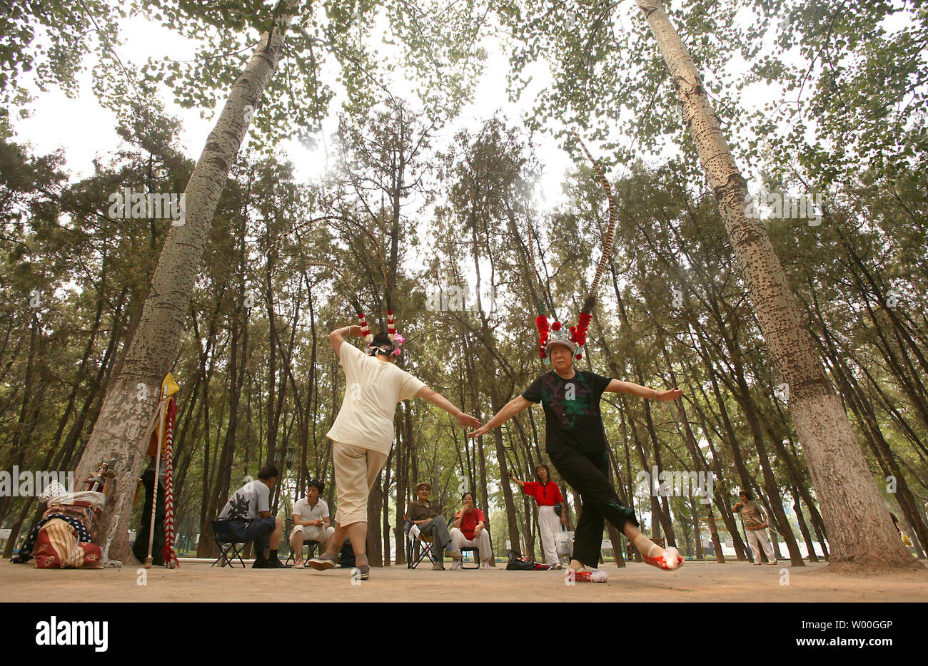 Chinese women practice a sword duel in their roles as traditional ...