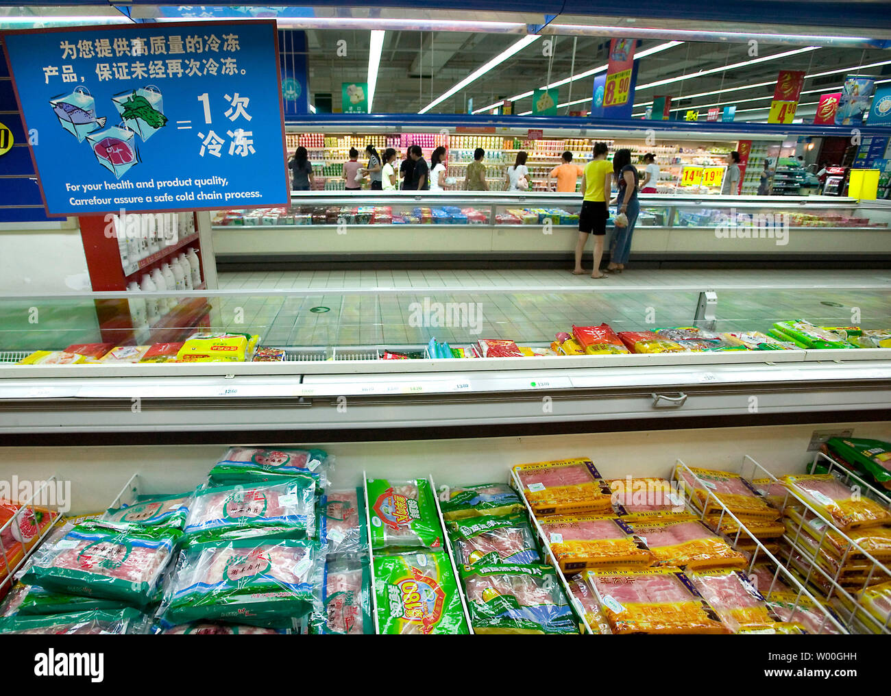 Chinese shoppers visit a Carrefour supermarket in downtown Beijing ...