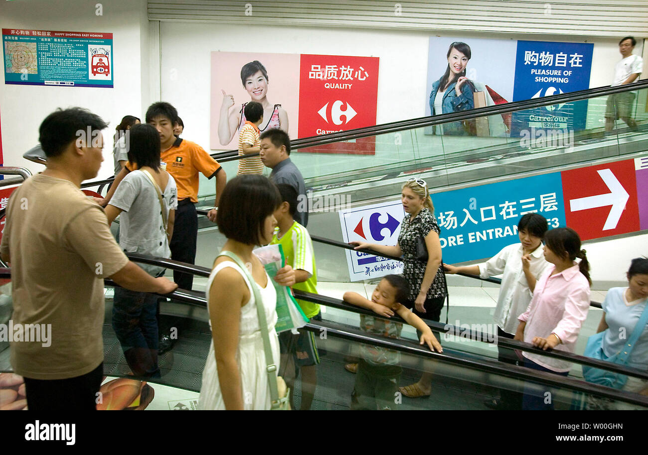 Chinese shoppers visit a Carrefour supermarket in downtown Beijing ...