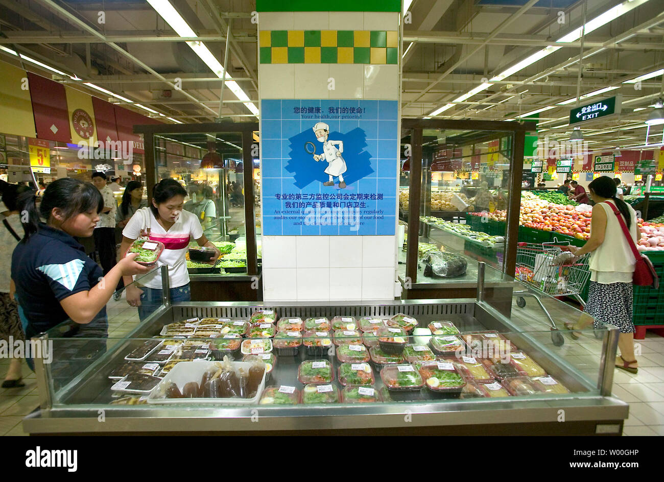 Chinese shoppers visit a Carrefour supermarket in downtown Beijing ...
