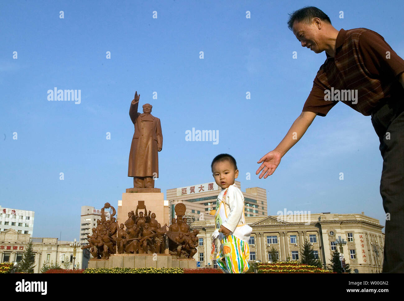 A Chinese father walks with his son near of one of the few remaining ...
