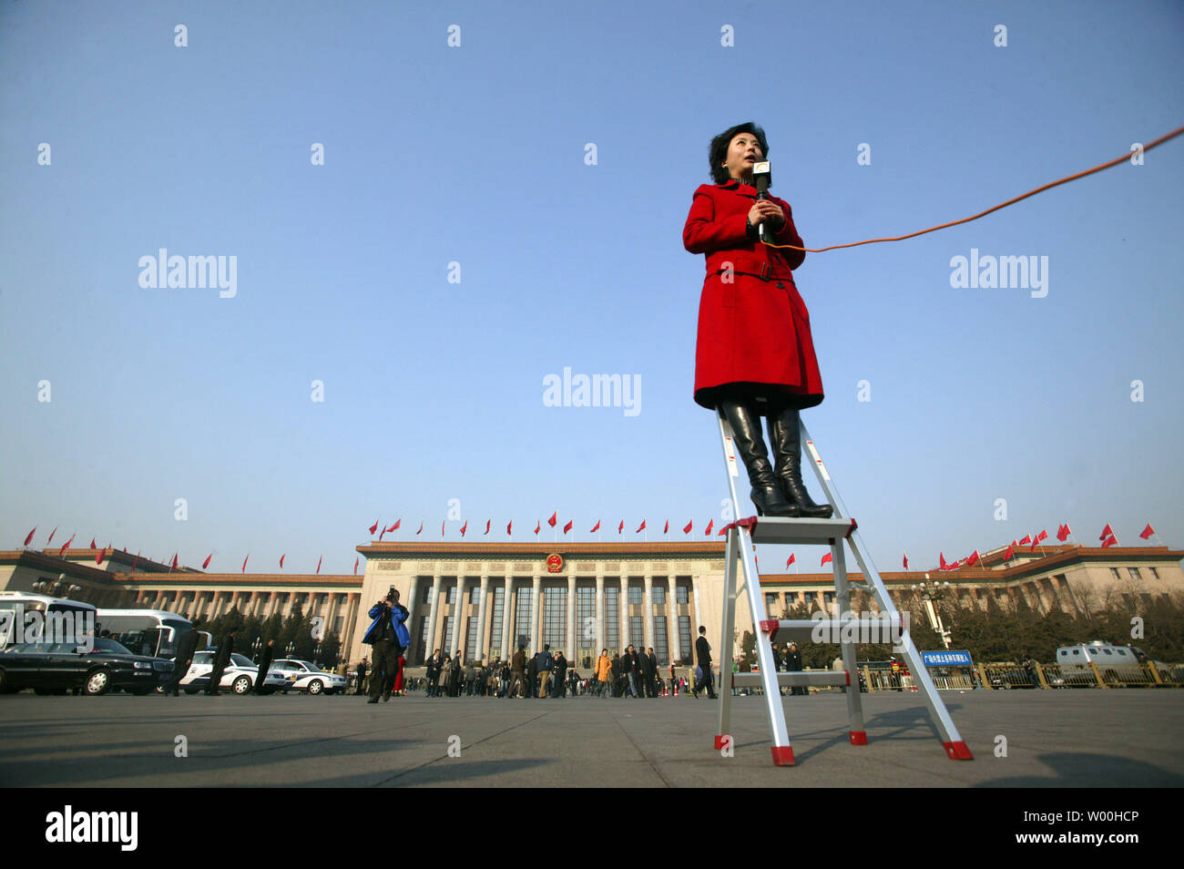 A Chinese reporter does a television stand-up outside the opening ...