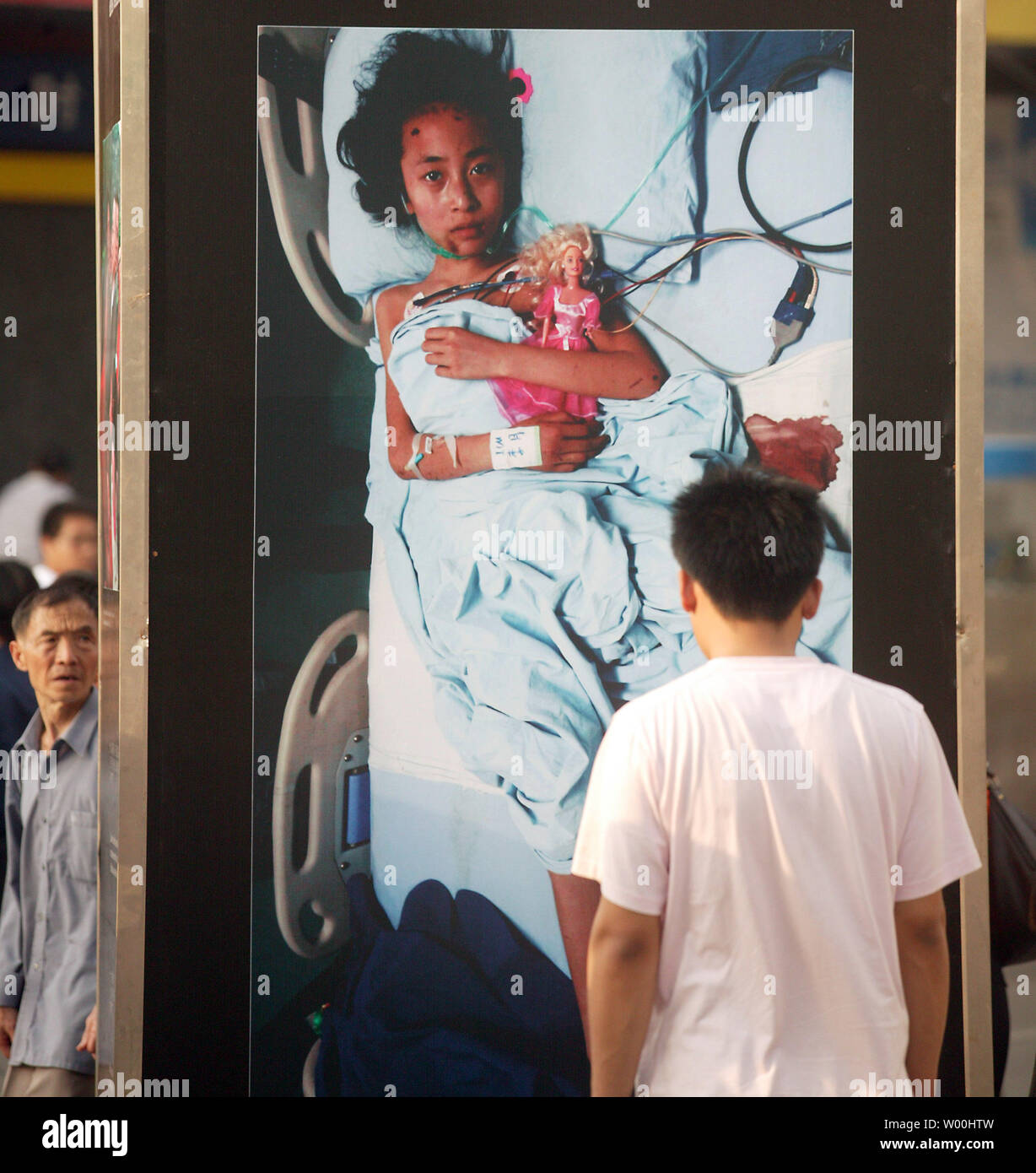 Chinese look at a new, outdoor exhibition of earthquake photographs in ...