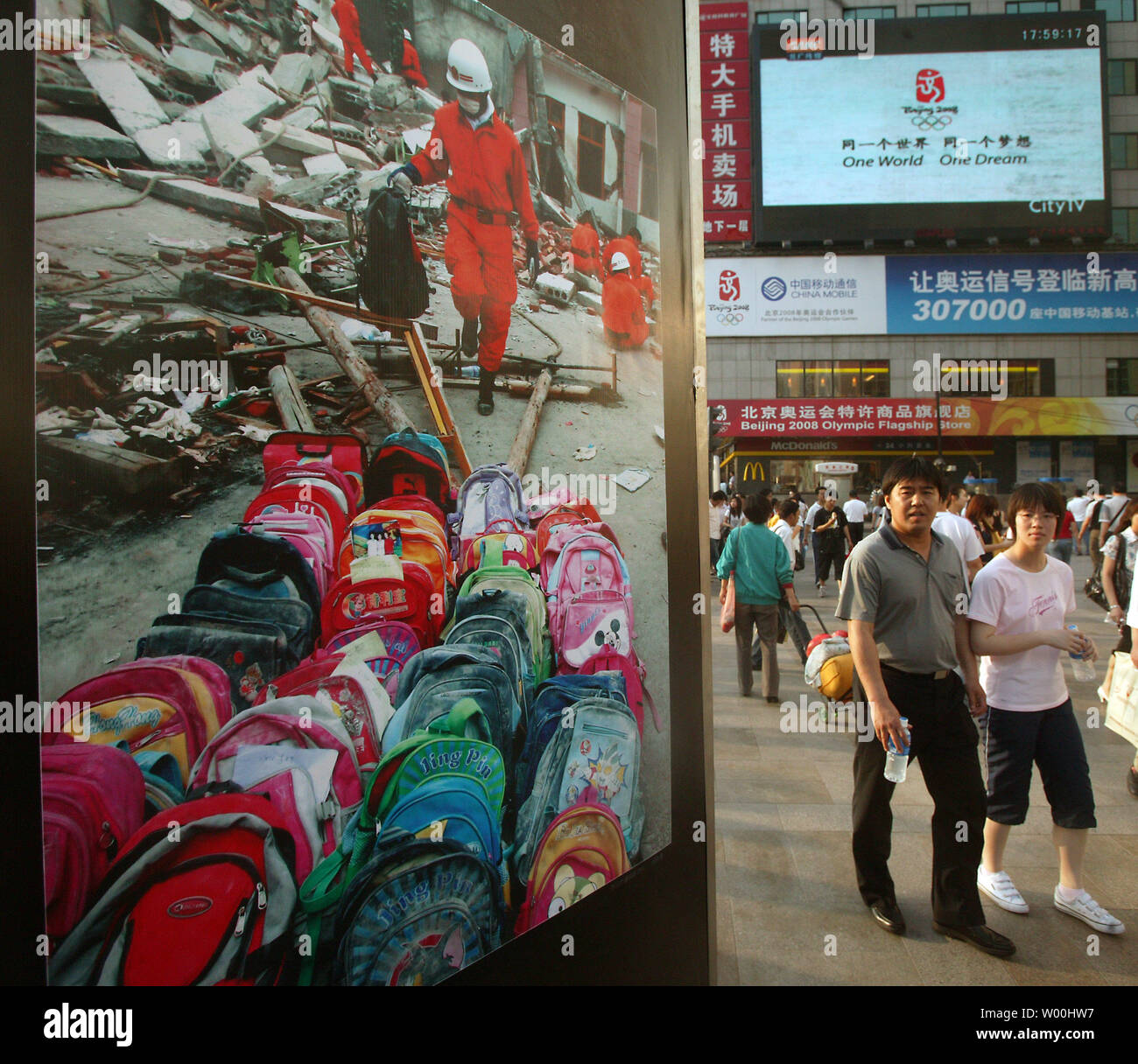 Chinese look at a new, outdoor exhibition of earthquake photographs in ...