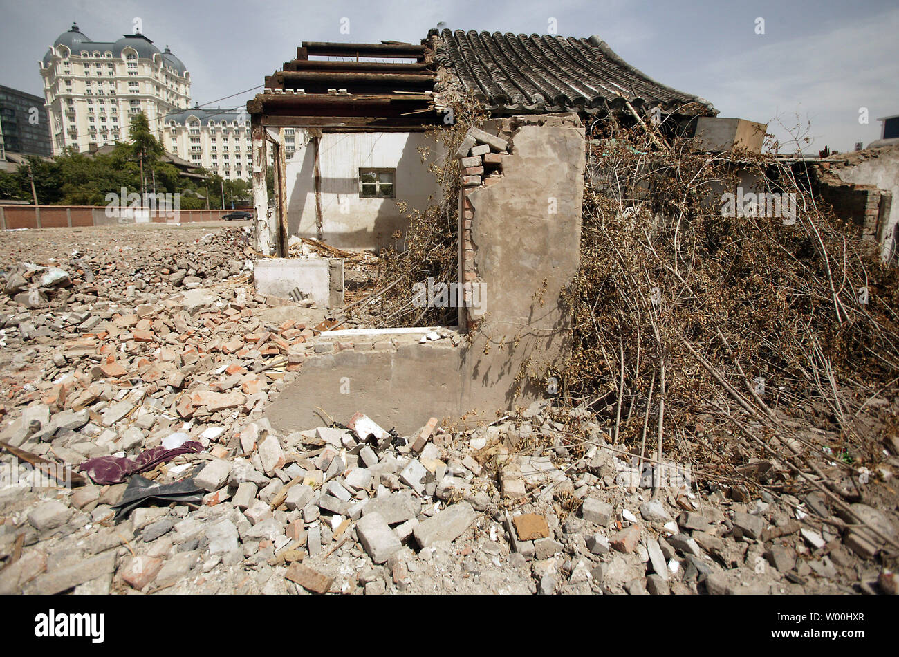 A lone, partly destroyed Chinese house sits in a recently demolished ...