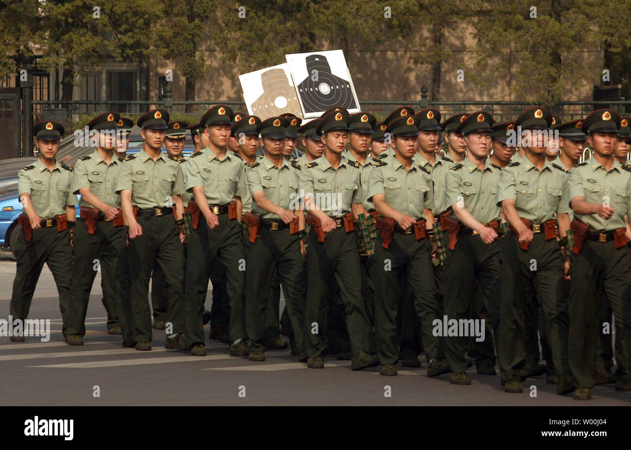Chinese soldiers carry training targets as they march back to their ...