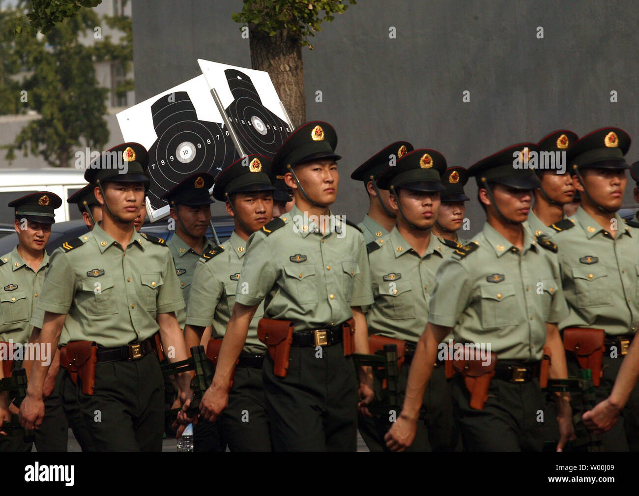 Chinese soldiers carry training targets as they march back to their ...