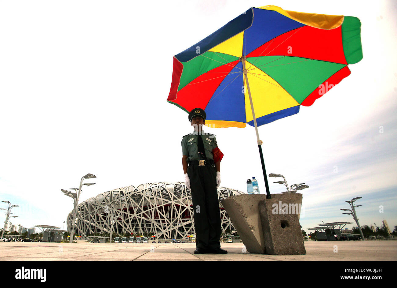 A Chinese security guard stands at one of dozens of checkpoints ...