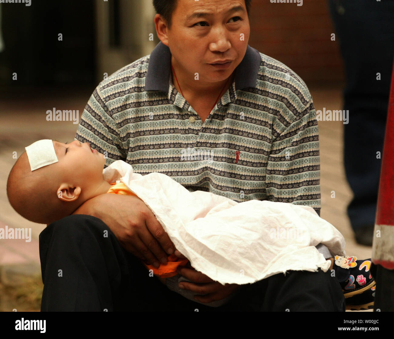 A Chinese father brings his son to a children's hospital in Beijing on ...