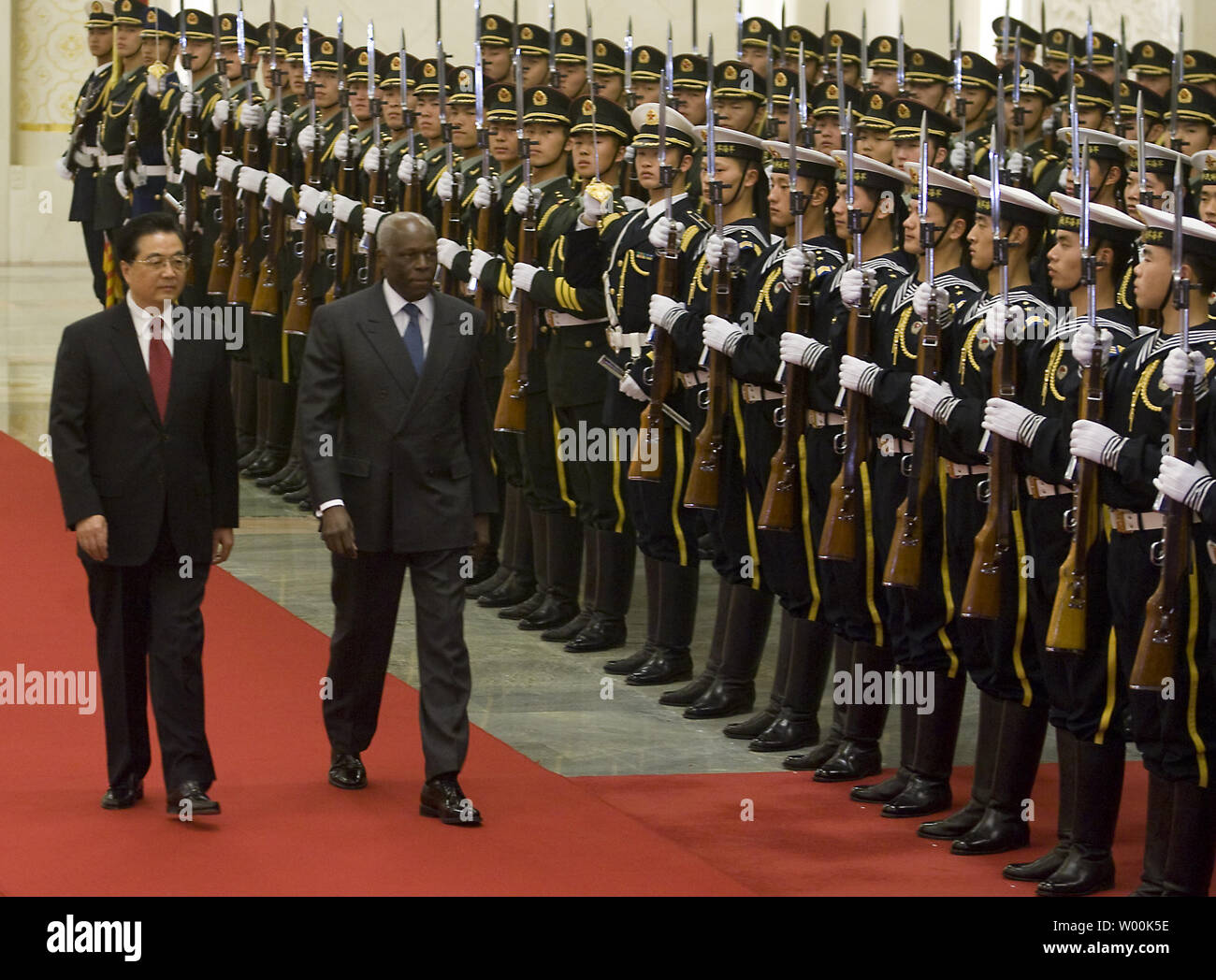 Angolan President Jose Eduardo dos Santos (R) is escorted past a ...