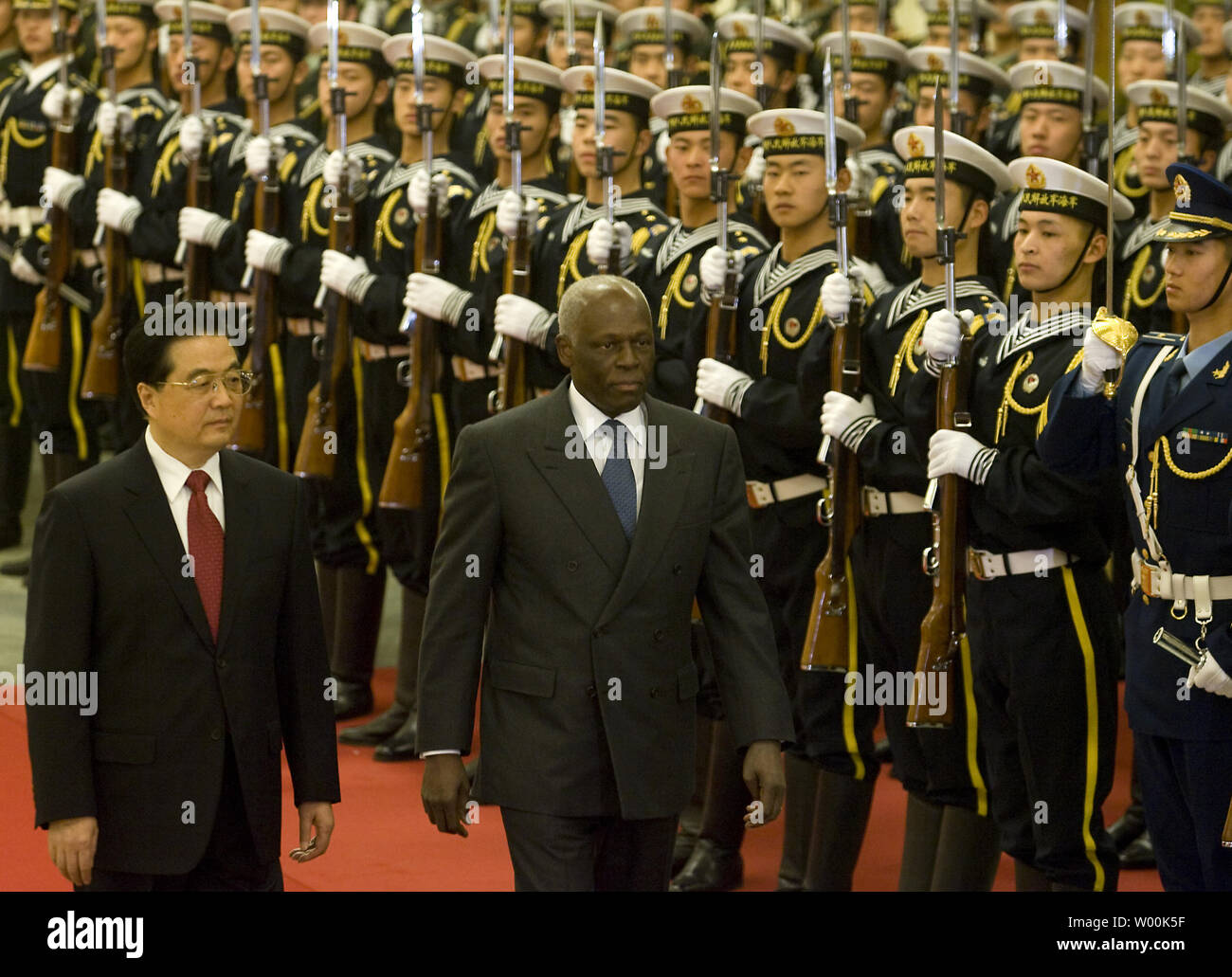 Angolan President Jose Eduardo dos Santos (R) is escorted past a ...