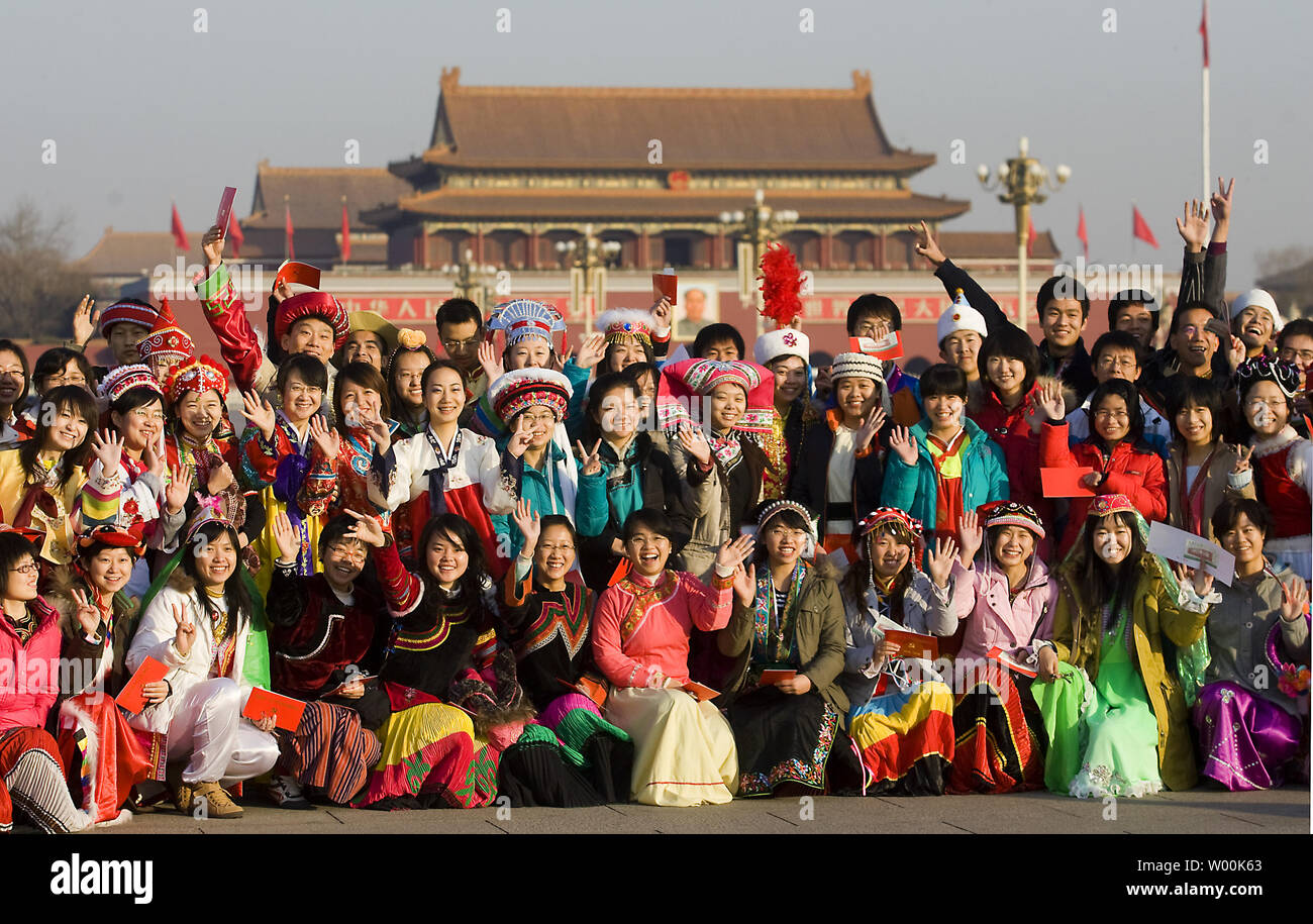 Chinese ethnic minorities pose for a group photograph as they arrive ...