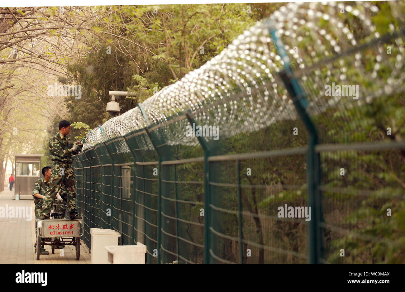 Chinese soldiers reinforce a security fence with barbed wire in the ...