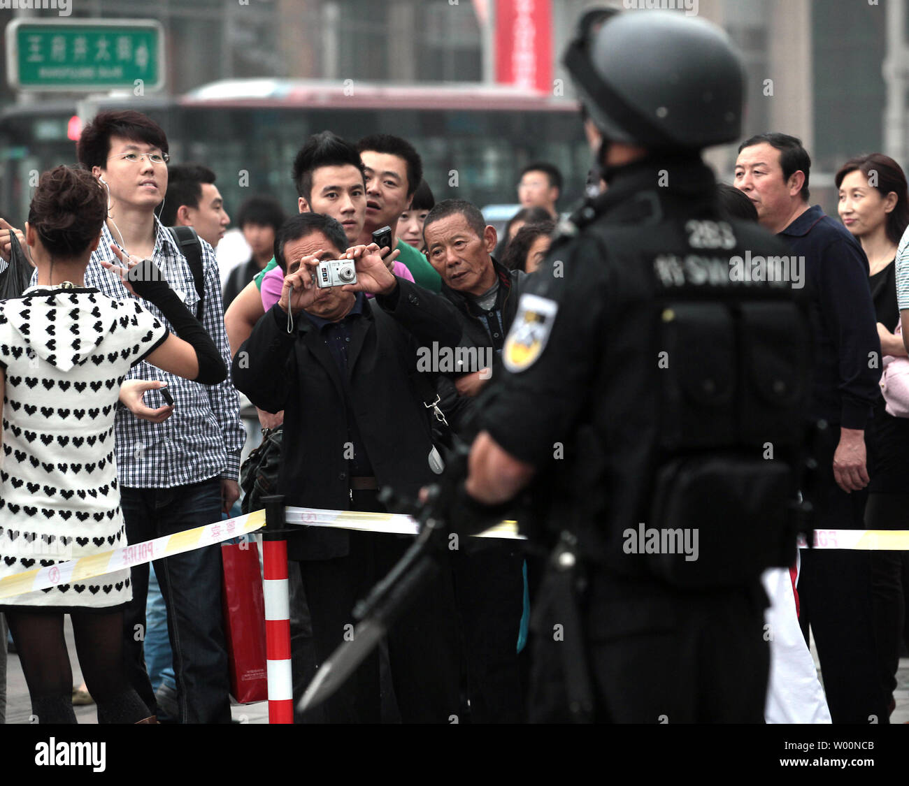A Chinese SWAT team with bayoneted automatic rifles stand guard next to ...