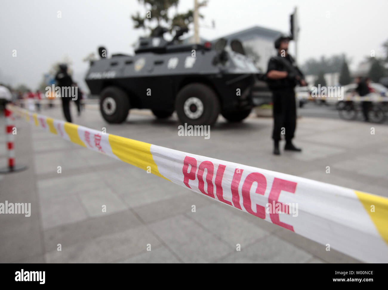A Chinese SWAT team with bayoneted automatic rifles stand guard next to ...
