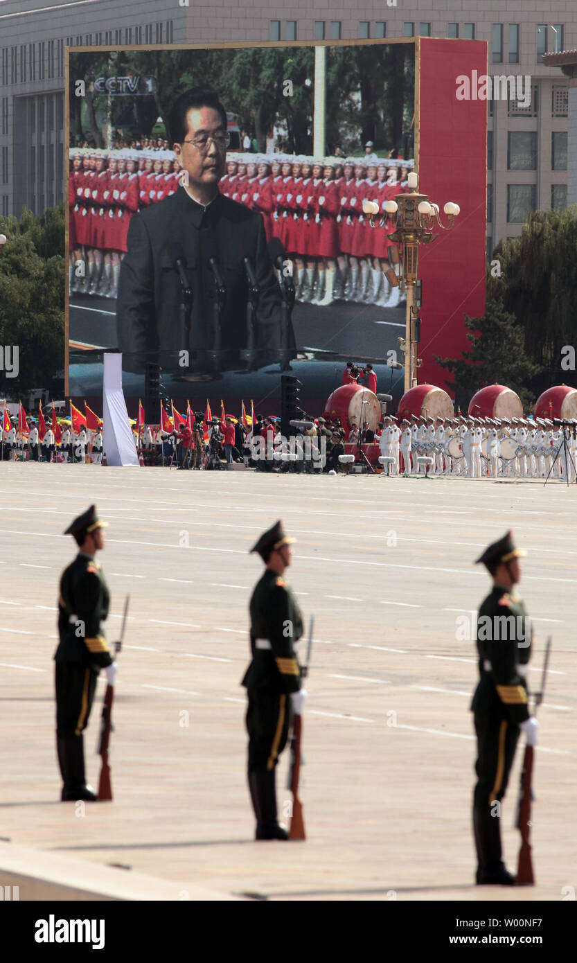 China's President Hu Jintao stands in the open roof of a limousine as ...