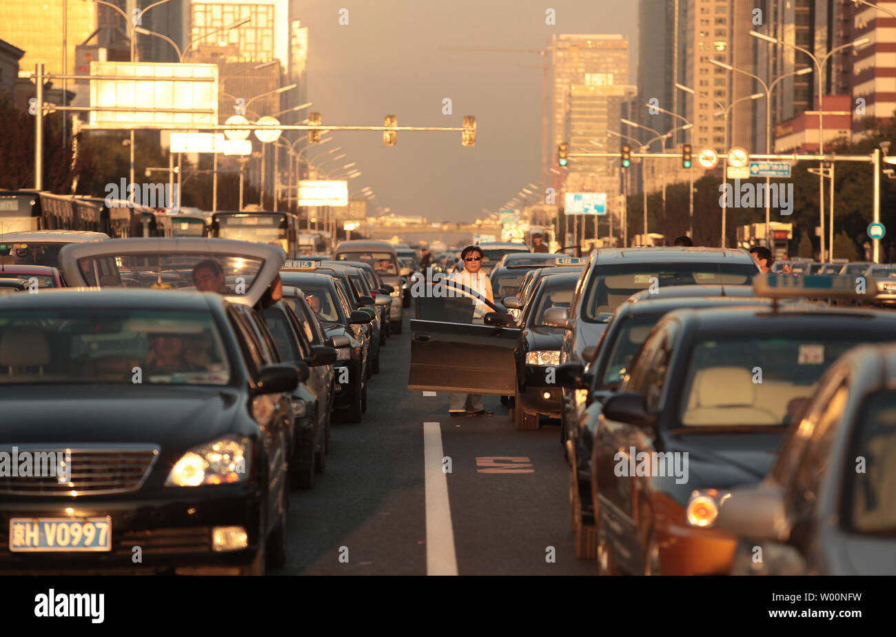Traffic comes to a halt as a motorcade passes through central Beijing ...