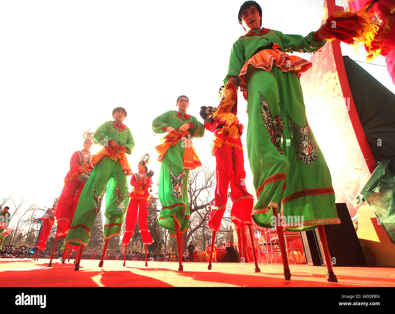 Chinese performers walk on stilts at a temple fair during China's ...