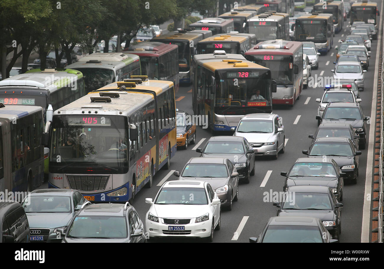 Heavy traffic grinds along a main road running through downtown Beijing ...