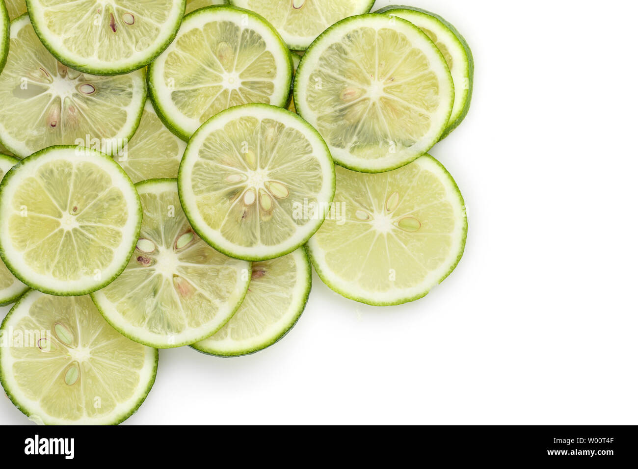Green lemon slices on white background Stock Photo - Alamy