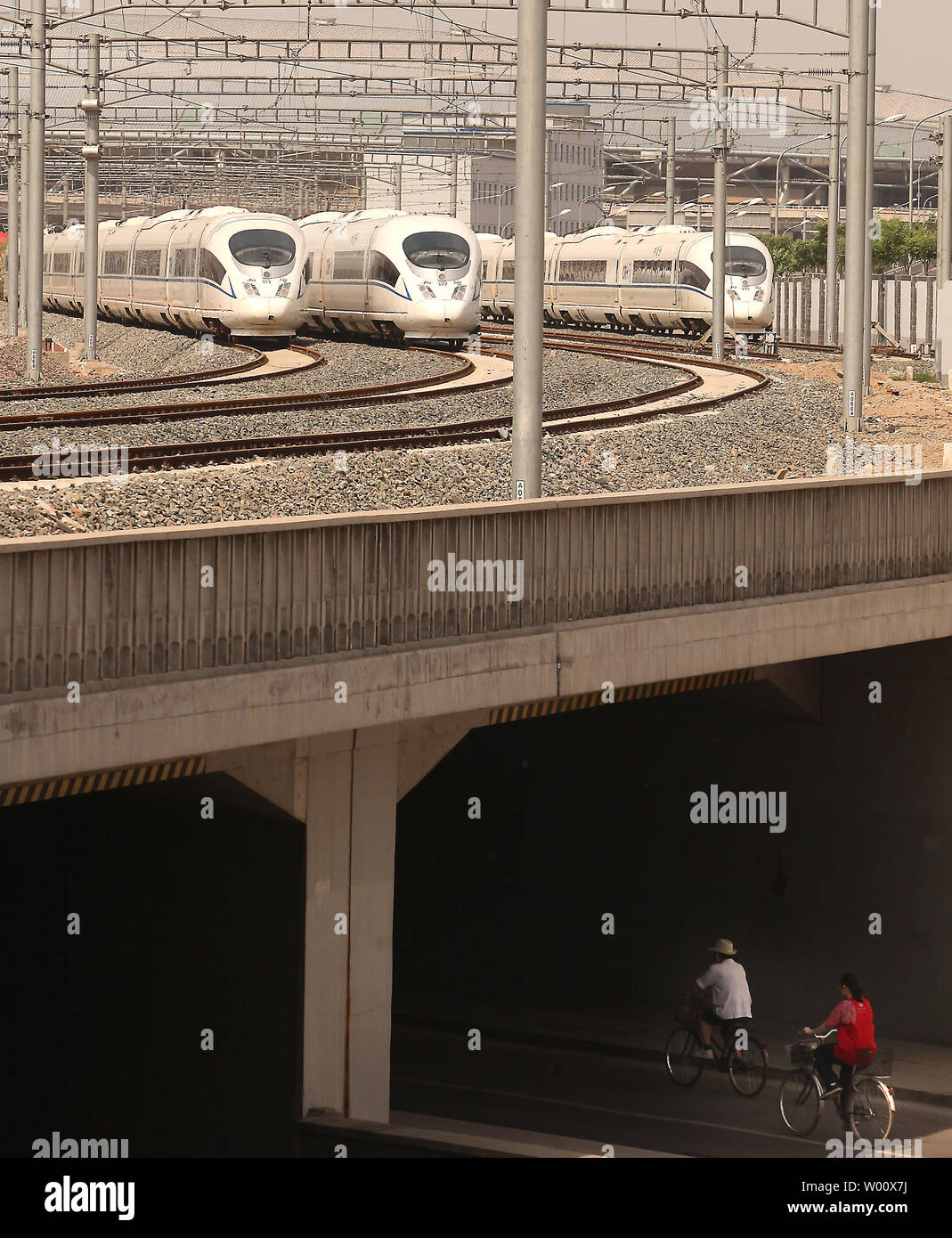 Chinese high-speed trains sit on tracks outside Beijing's new, southern ...