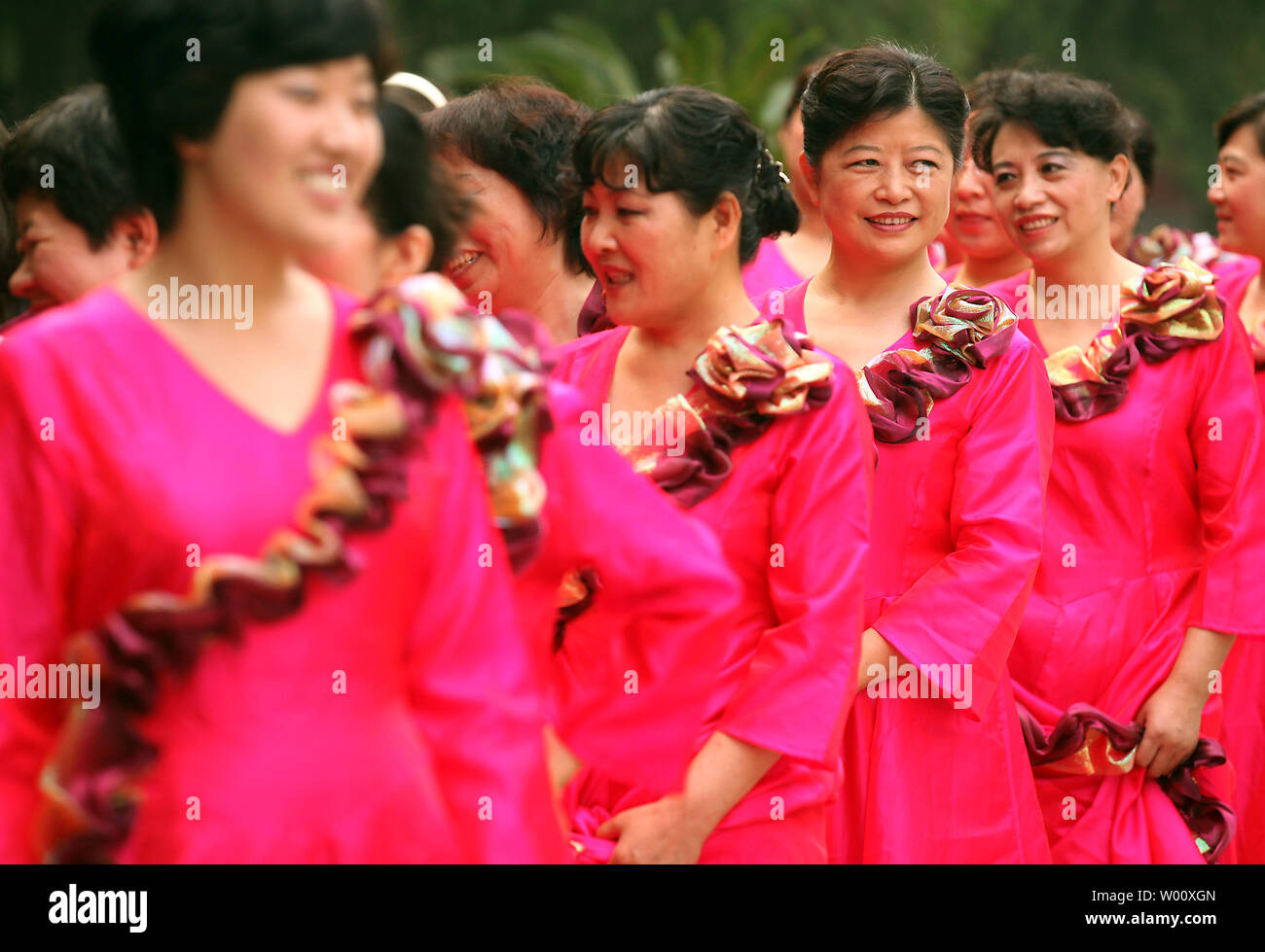 Chinese woman prepare to perform Chinese Communist songs during an ...
