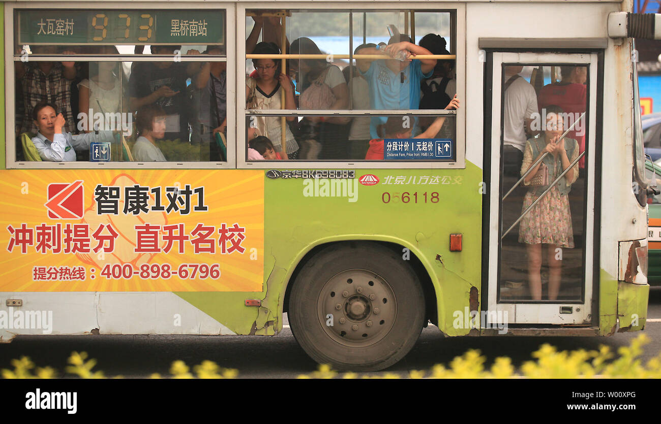 A city bus tightly packed with Chinese commuters waits at an ...