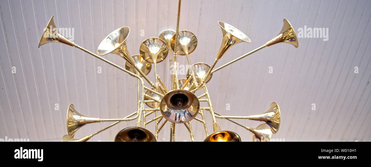 Brass Horns are turned into artwork and hanging from the ceiling Stock ...