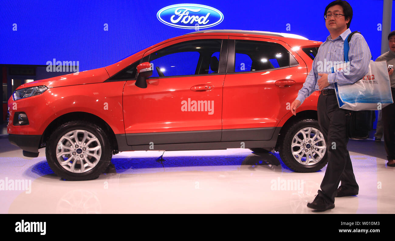 A Chinese visitor checks out Ford's new Eco Sport on display at the ...