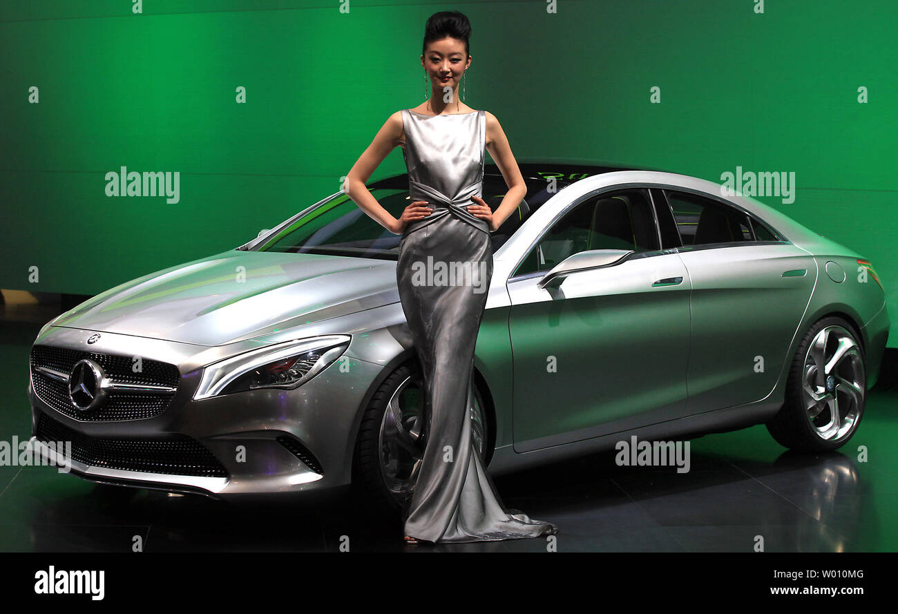 A Chinese model poses next to Mercedes-Benz's new concept car, the ...