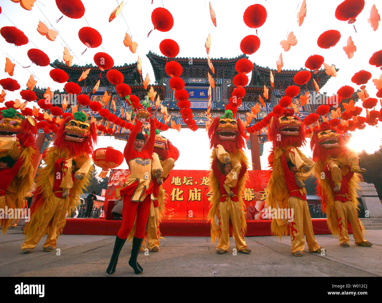 Chinese artists perform a traditional lion dance at the opening ...