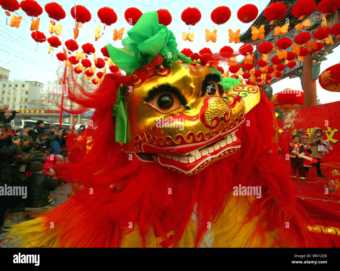 Chinese artists perform a traditional lion dance at the opening ...