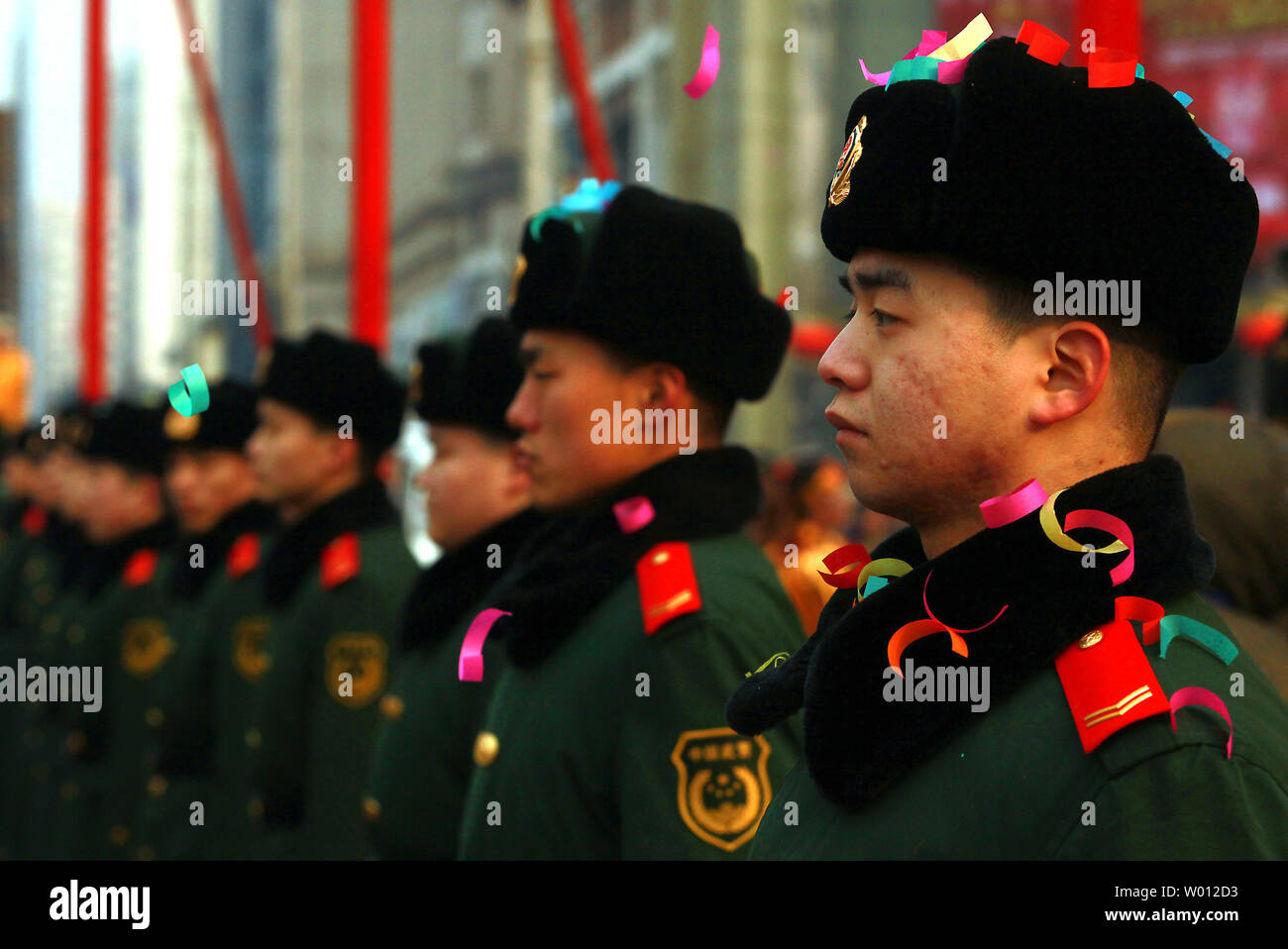 Soldiers stand in confetti while guarding Chinese artists performing a ...