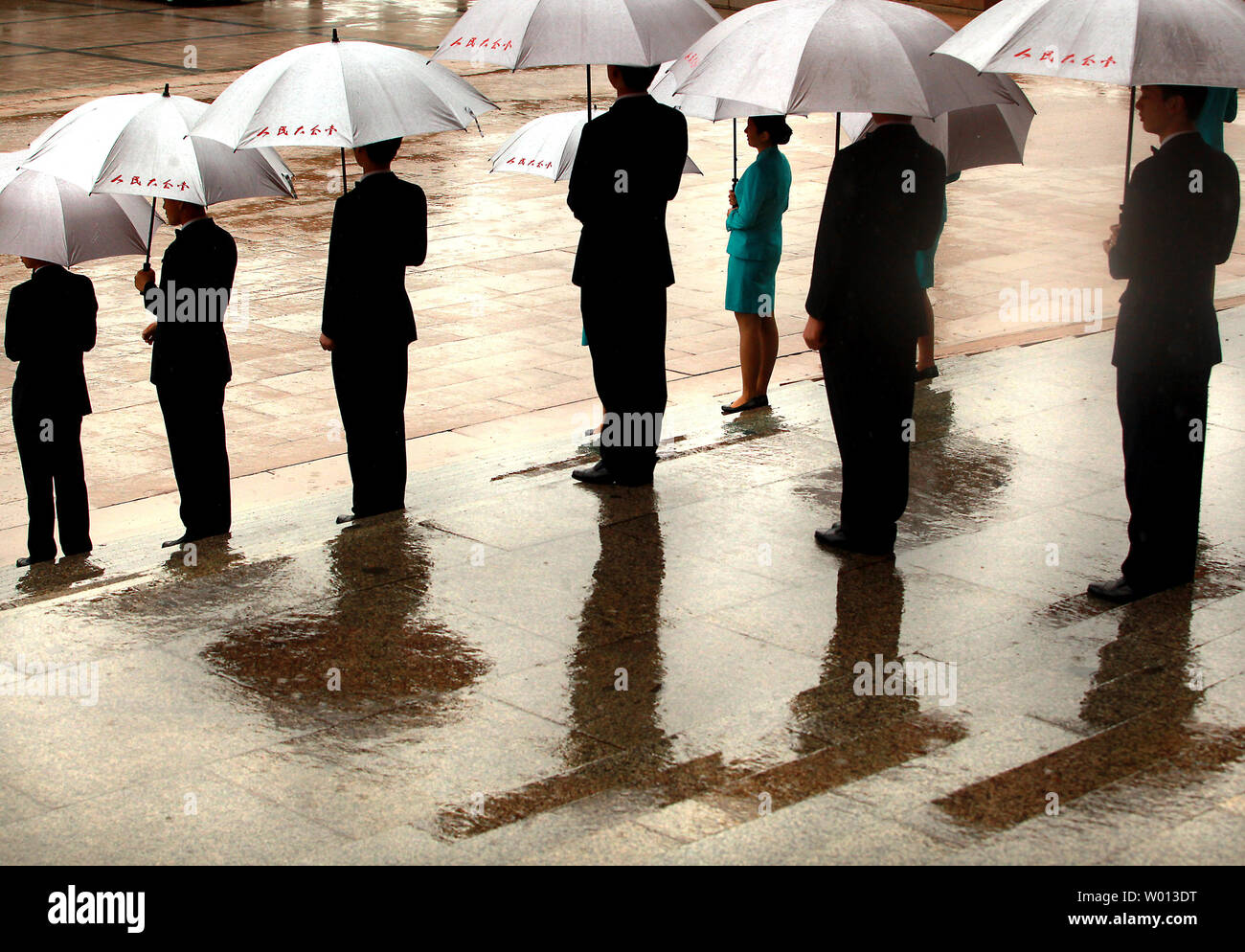 Chinese staff wait for the visiting Nigerian delegation on the steps of ...
