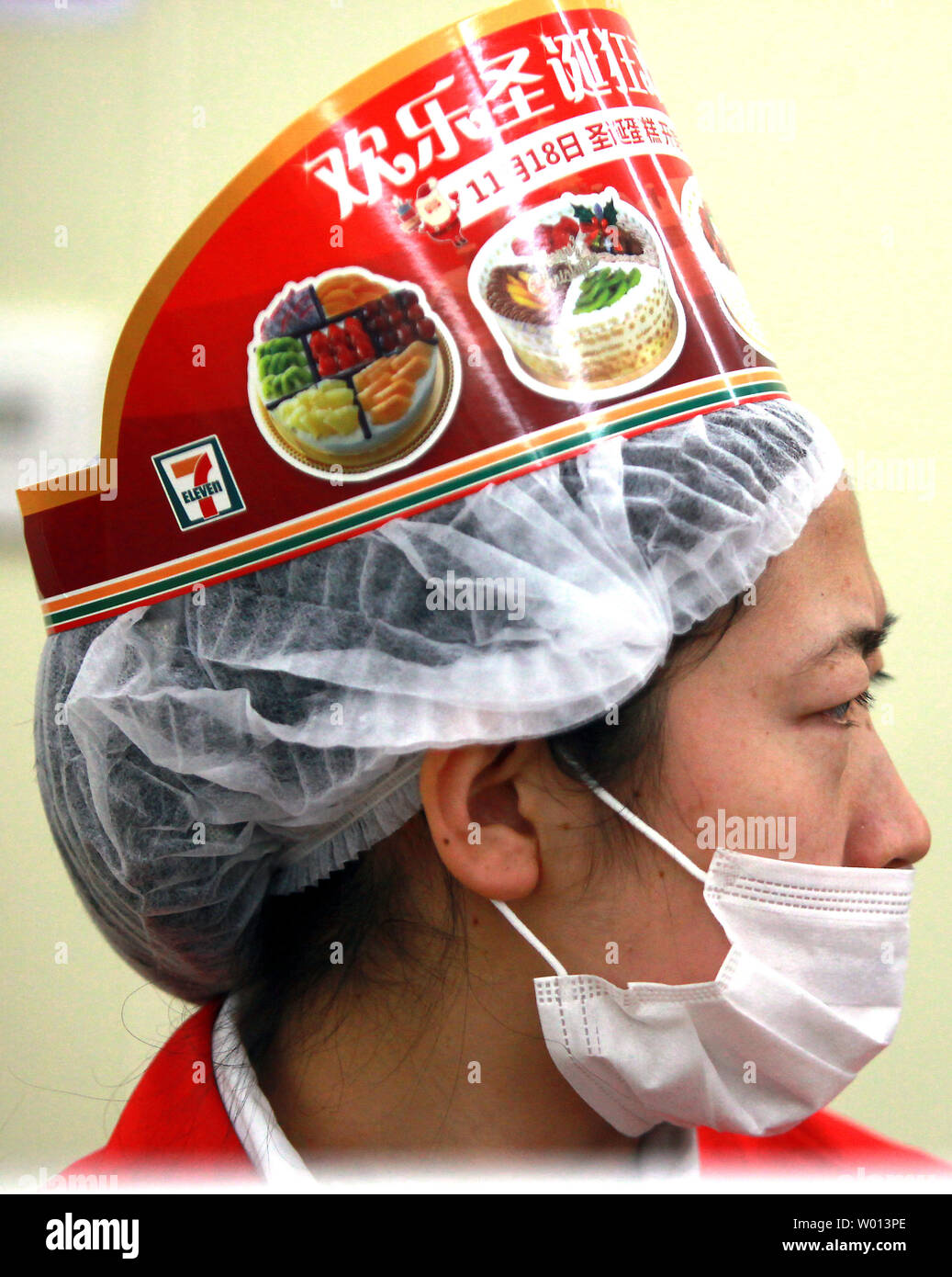 A Chinese employee for a 7-Eleven, one of nearly a thousand franchised ...