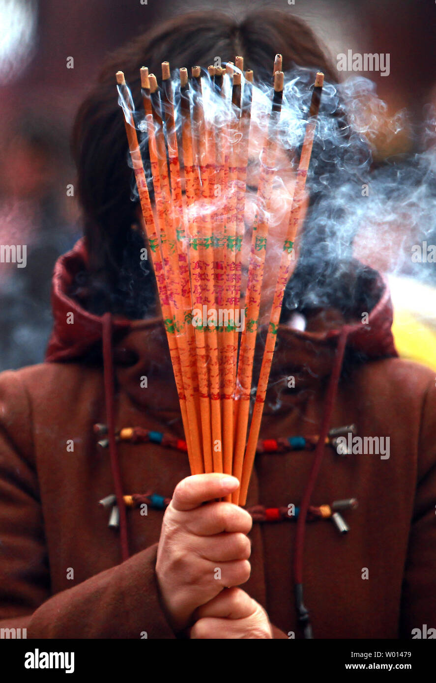 Chinese light incense sticks and pray at the Dongyue Taoist temple on ...