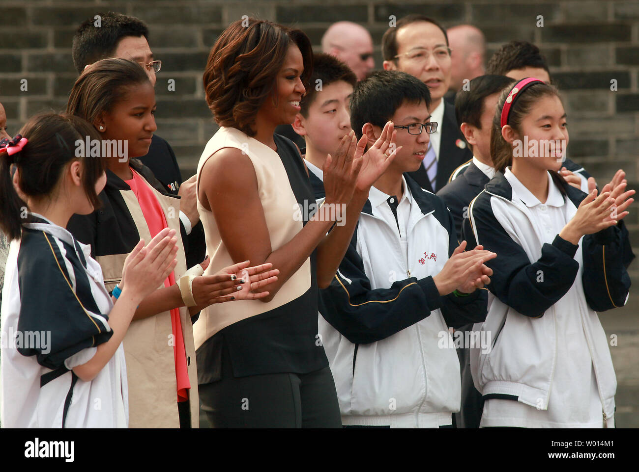 U.S. First Lady Michelle Obama and Malia watch students jump rope while ...