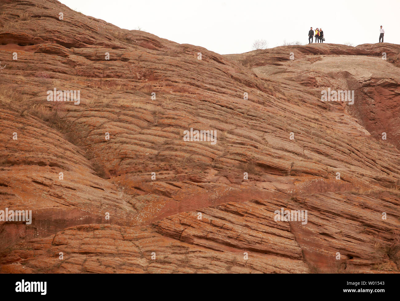 Chinese tourists explore an archeological site where prehistoric cave ...
