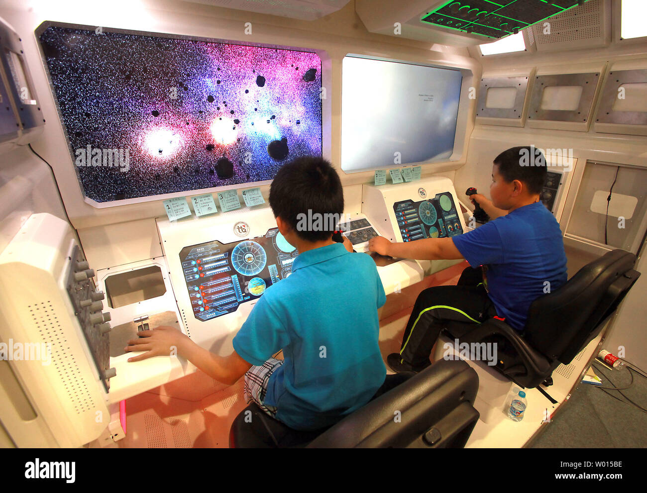 Chinese kids try their hand at flying in a futuristic space shuttle ...