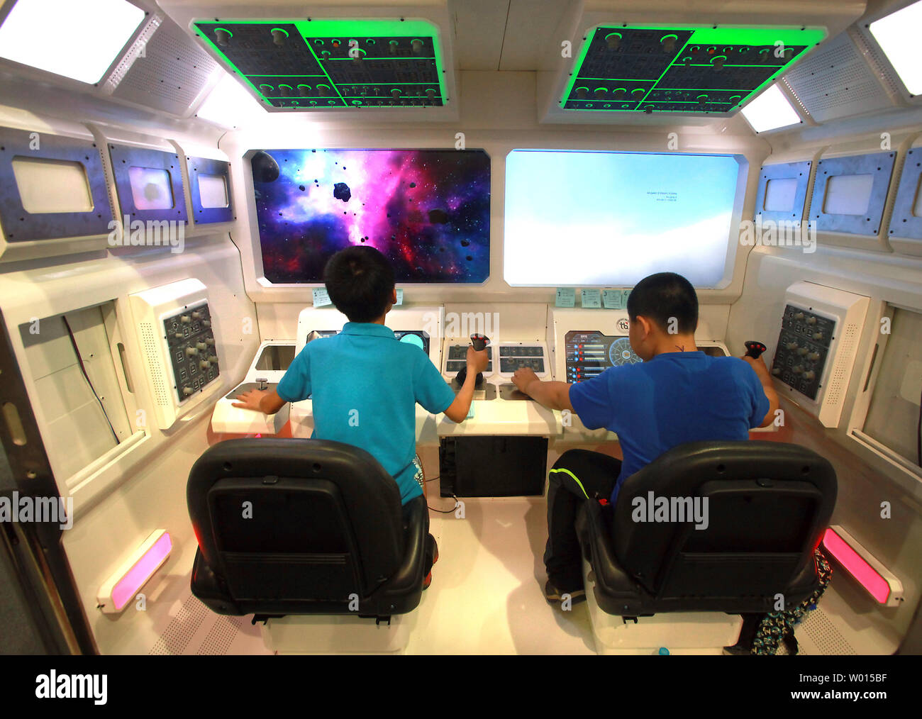 Chinese kids try their hand at flying in a futuristic space shuttle ...