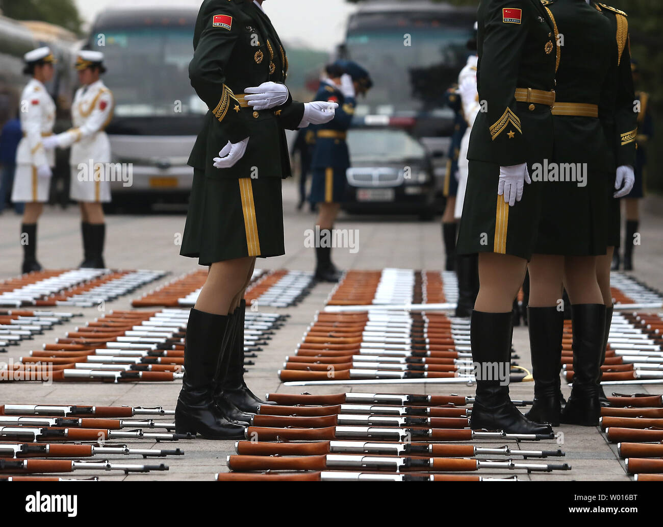Chinese soldiers prepare to perform honor guard duties at a welcoming ...