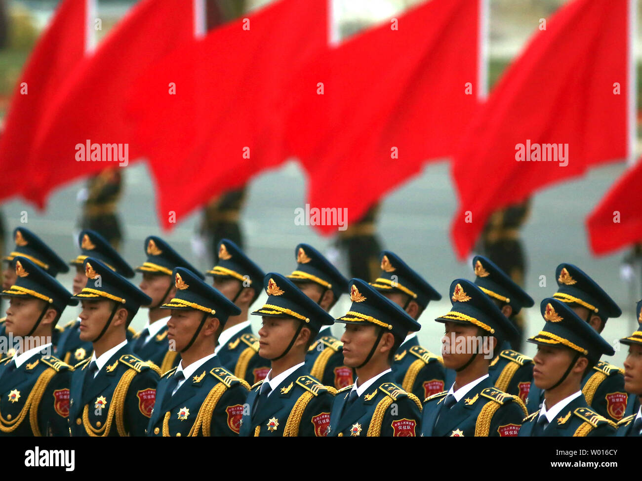 Chinese soldiers prepare to perform honor guard duties at a welcoming ...