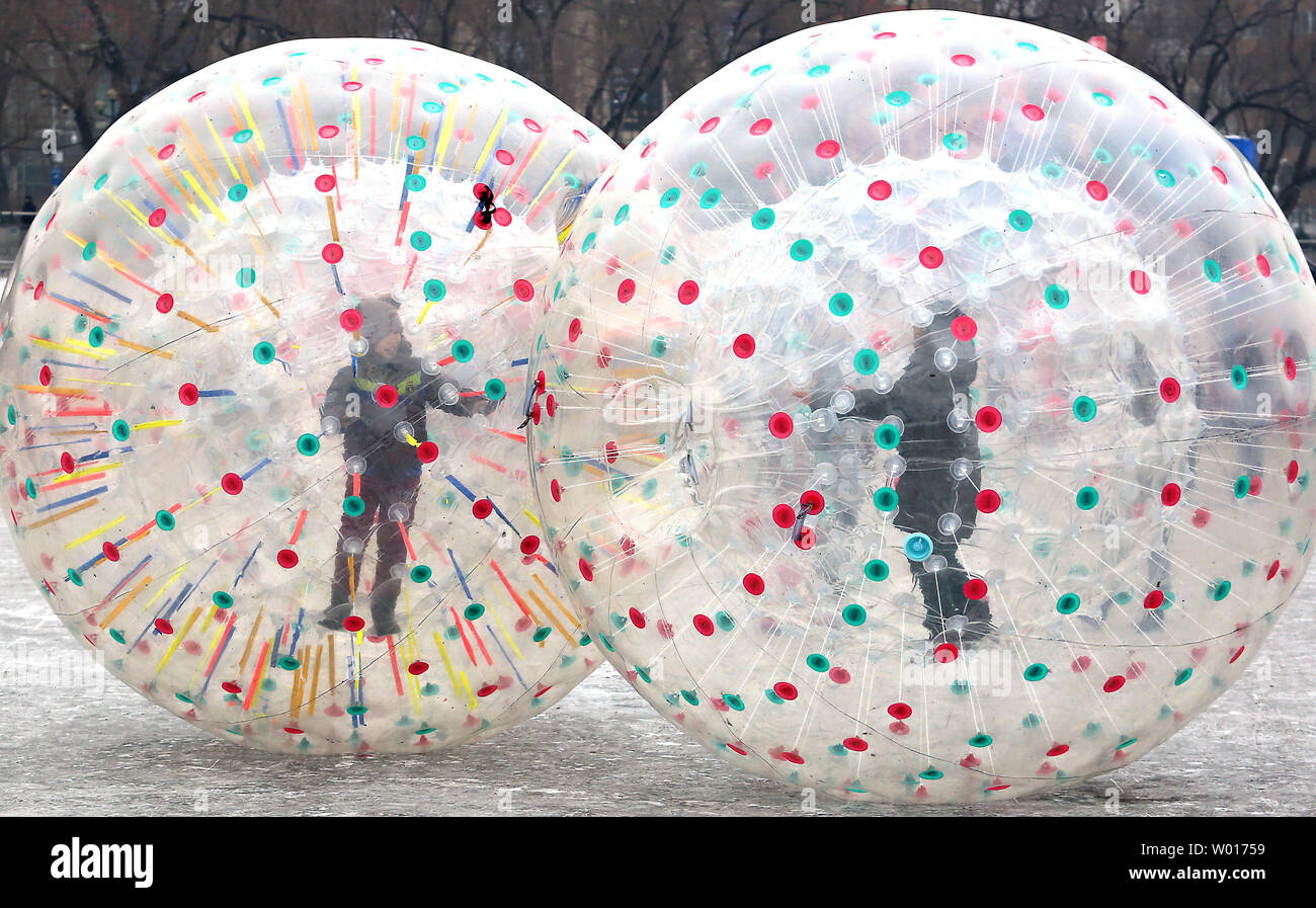Chinese boys have some fun inside an inflatable ball in Beijing on ...