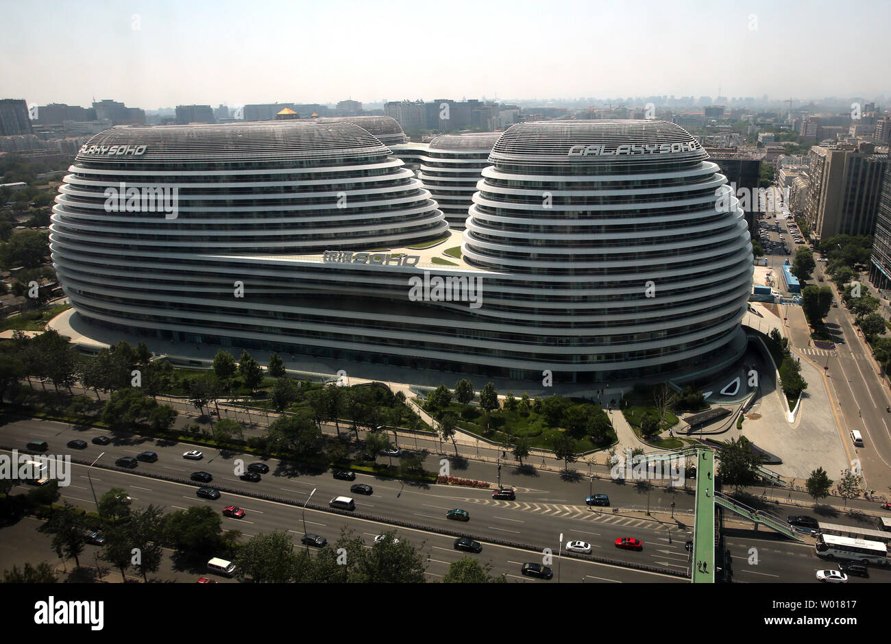 A modern business complex called the SOHO Galaxy stands in stark ...