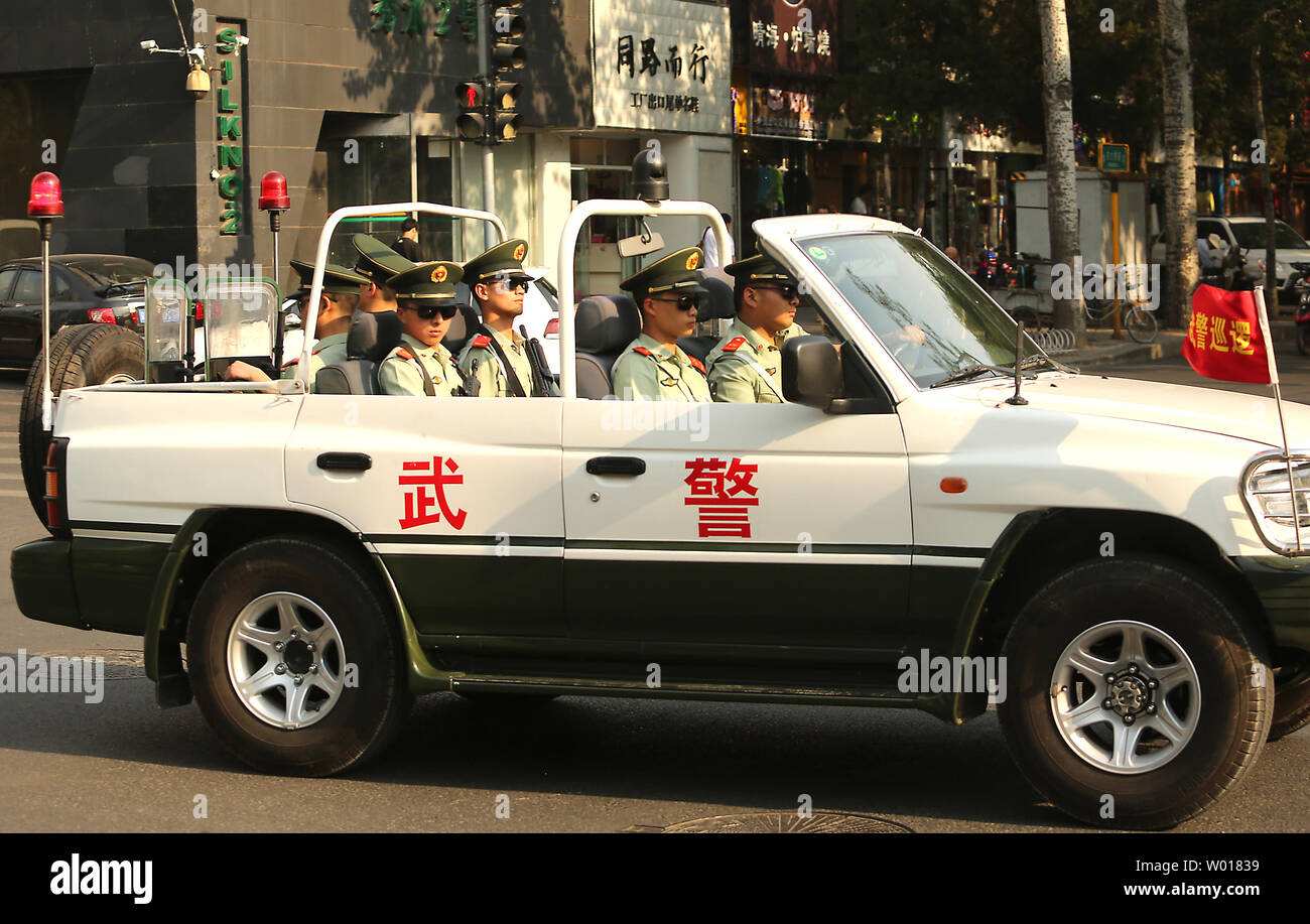 A Chinese jeep carries armed paramilitary soldiers while patrolling the ...