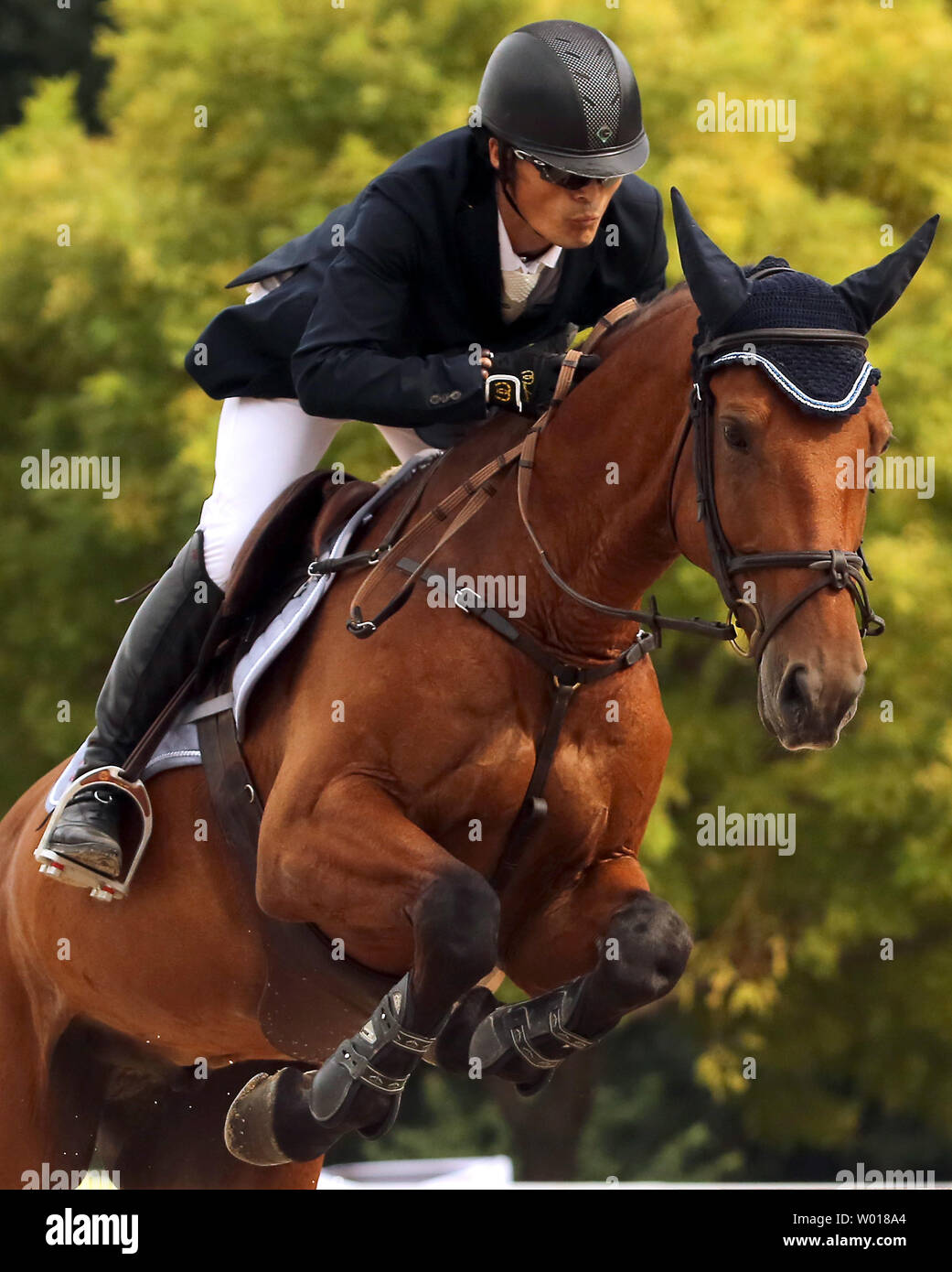 A Chinese jockey competes in the First China Show Jumping Open at the ...