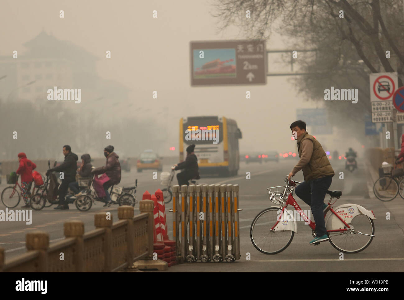 Chinese commute on bike under a thick smog near Tiananmen Square in ...
